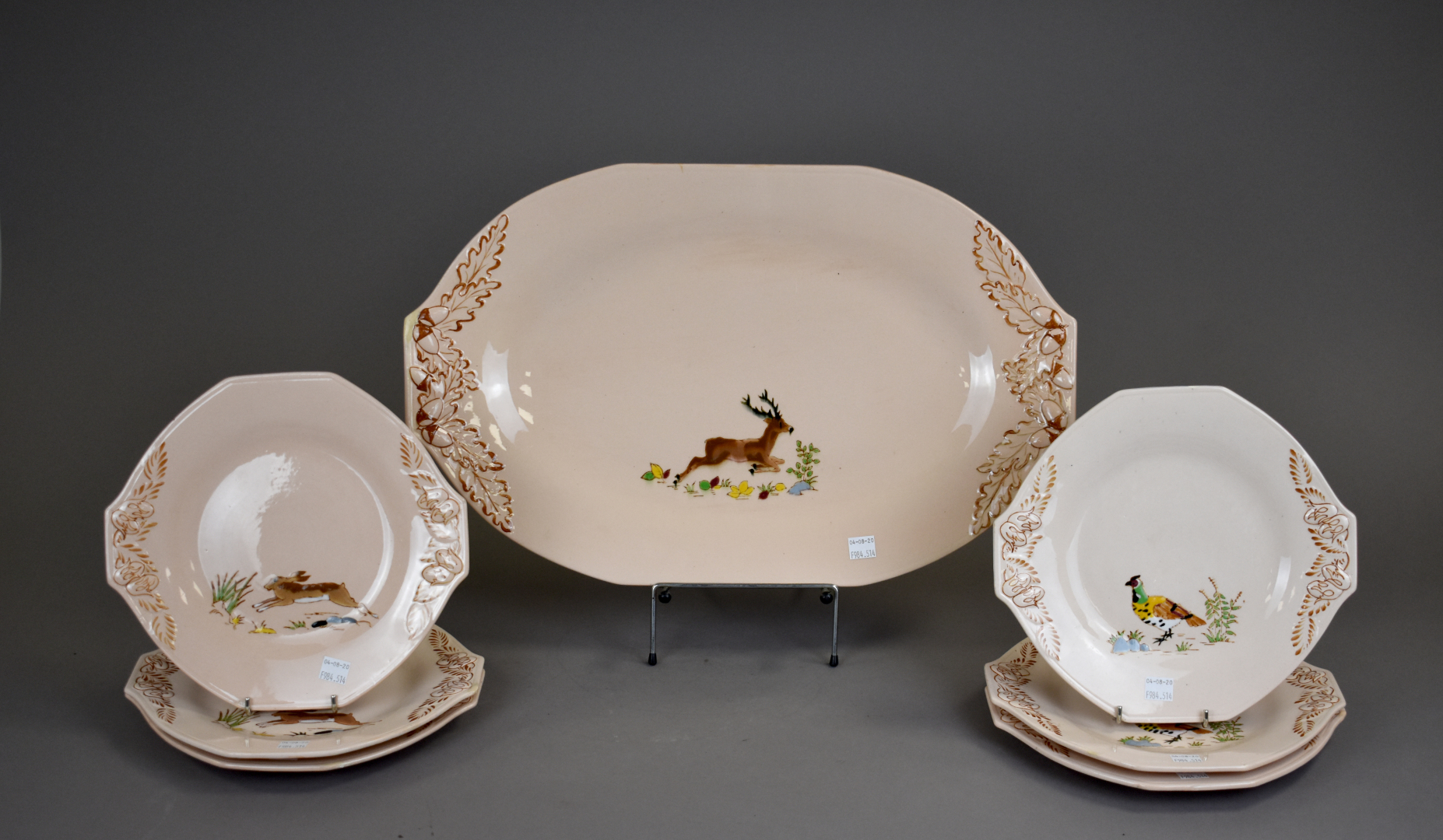 LONGWY. Service de table en faïence beige à décor de gibier, feuilles ...